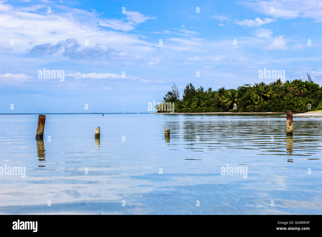 Sunny beach with sky reflecting on sea Stock Photo - Alamy