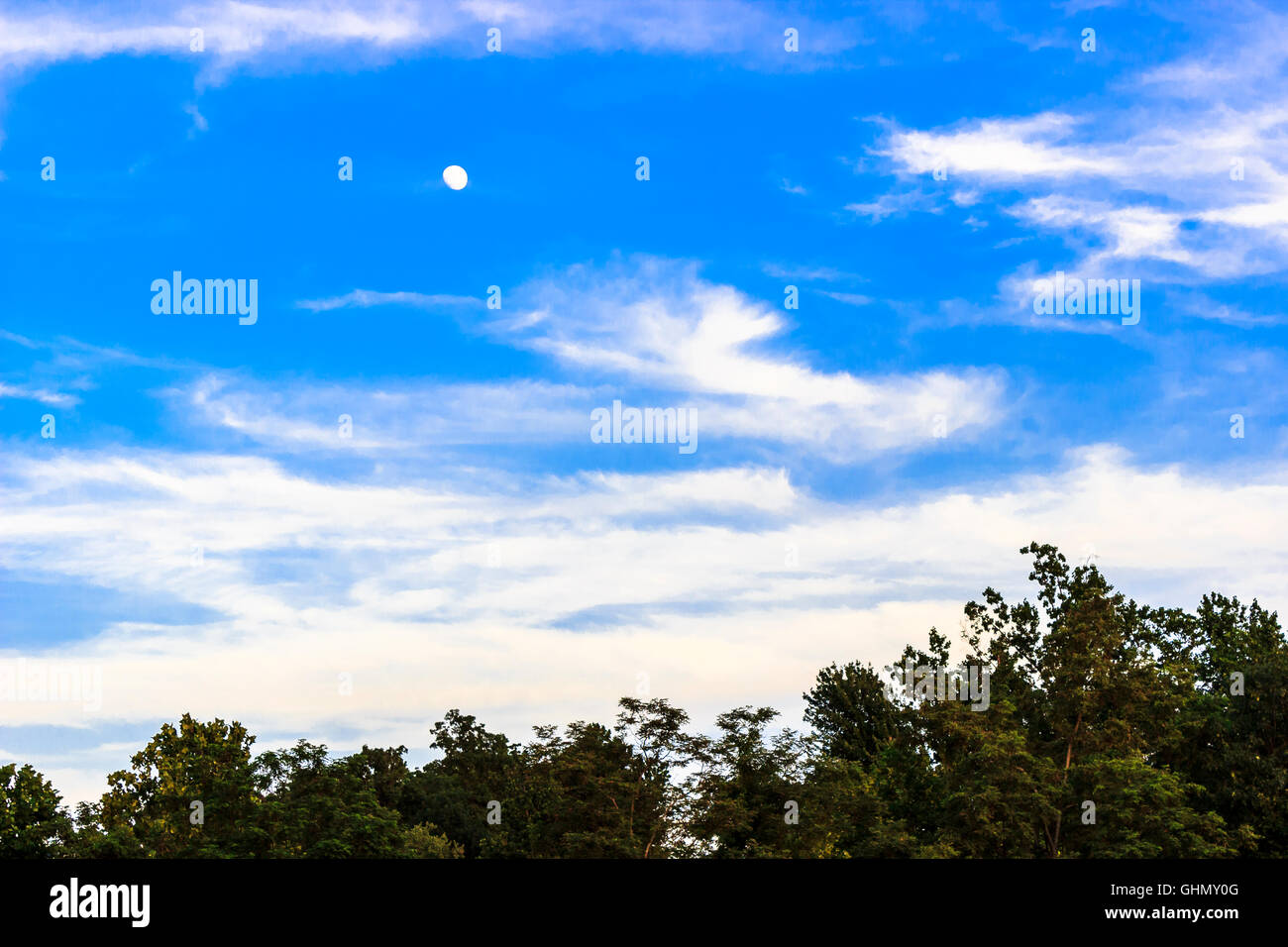 Moon on blue and cloudy sky Stock Photo - Alamy