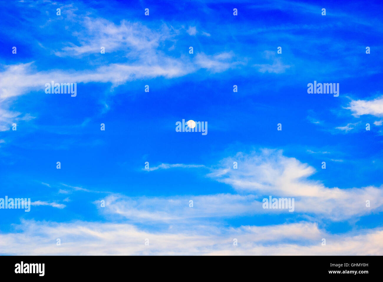 Moon on blue and cloudy sky Stock Photo - Alamy
