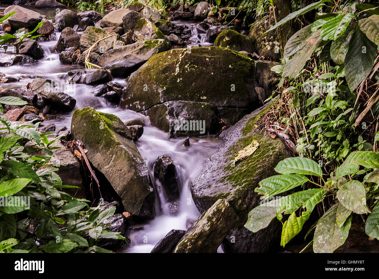 Water stream moving through rocks Stock Photo - Alamy