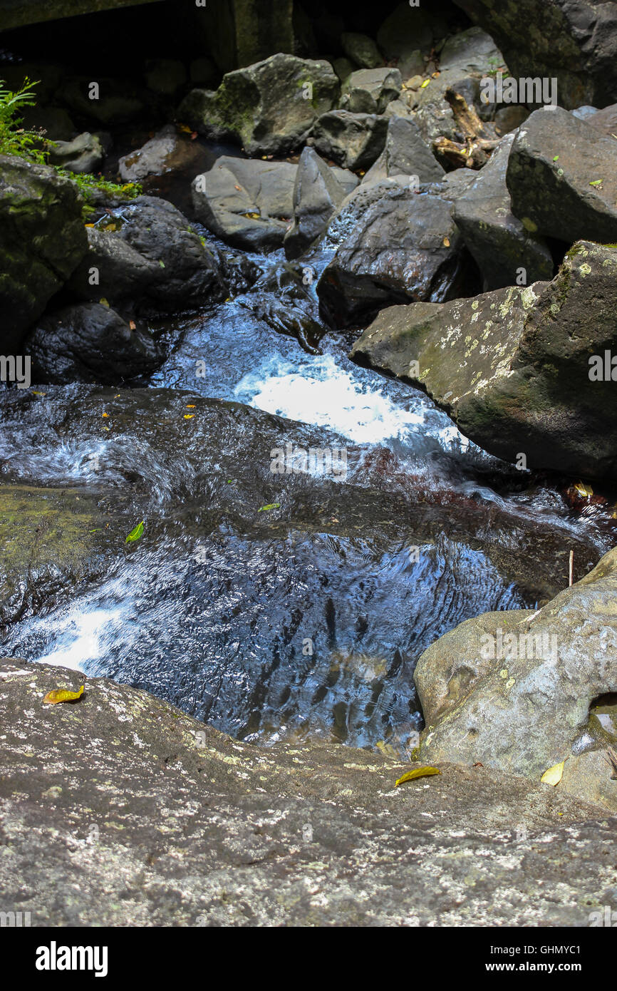 Water stream moving through rocks Stock Photo - Alamy