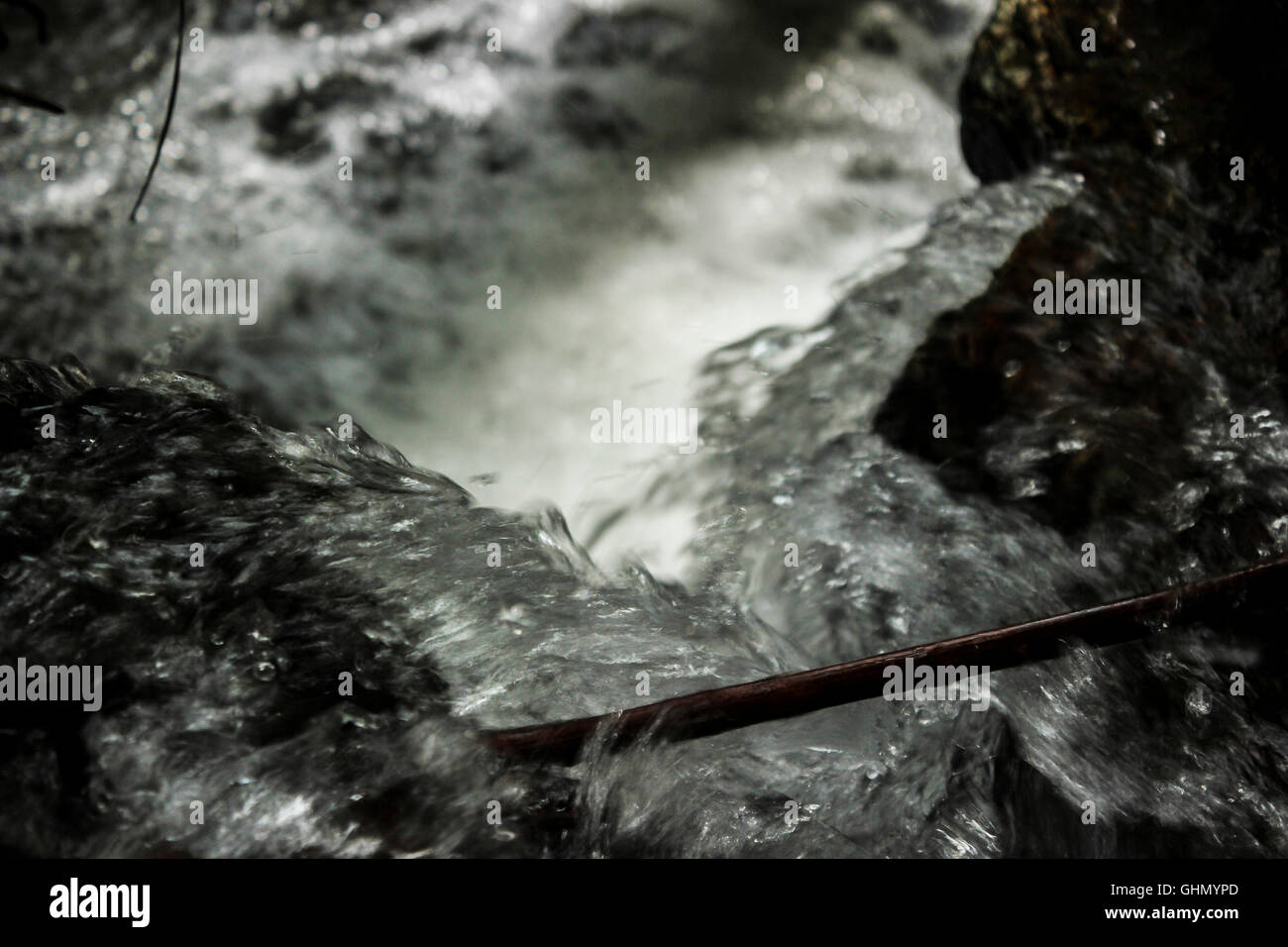 Water stream moving through rocks Stock Photo - Alamy