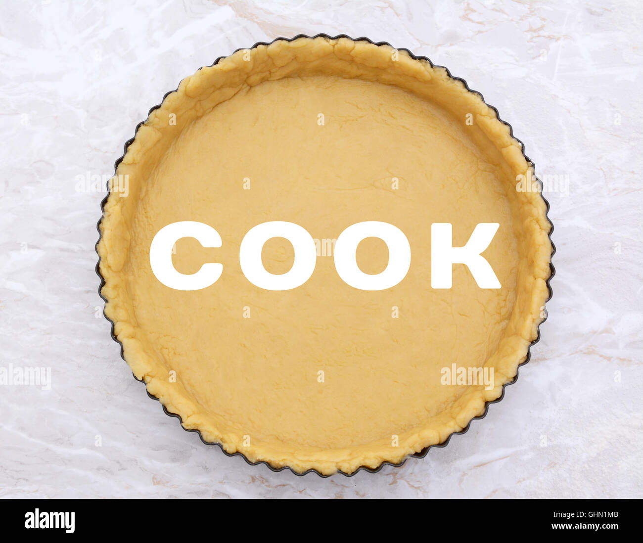 COOK text written across pastry lined metal tin on a kitchen work ...