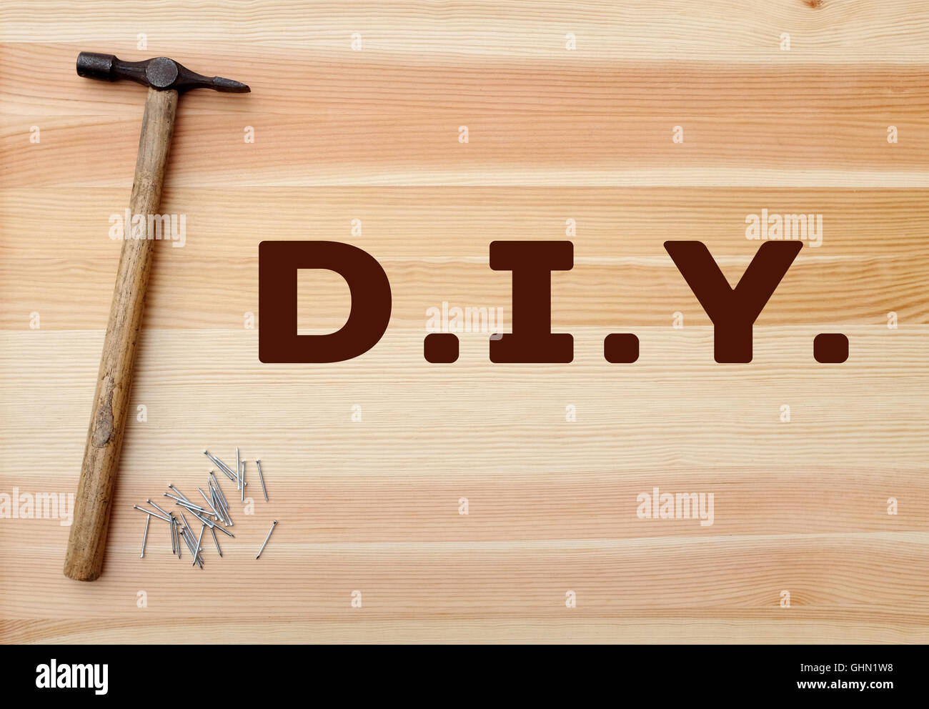 Hammer and metal panel pins with DIY concept written on a wooden ...