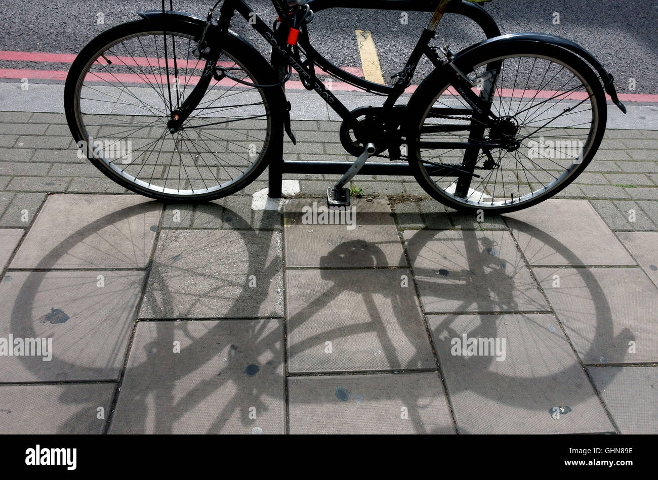 Parked bicycle with shadow, London Stock Photo - Alamy