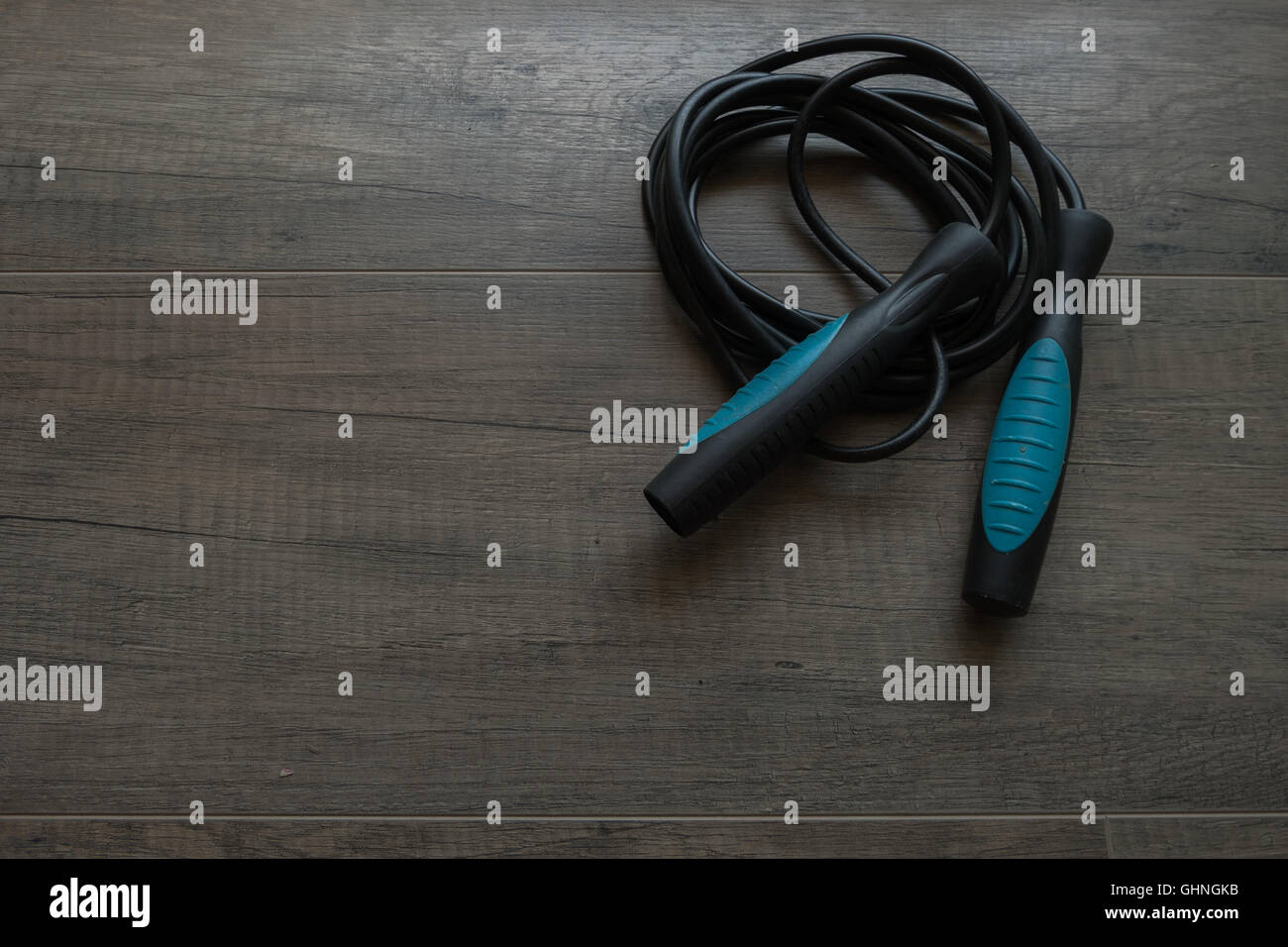 Blue jump rope on wooden background Stock Photo - Alamy