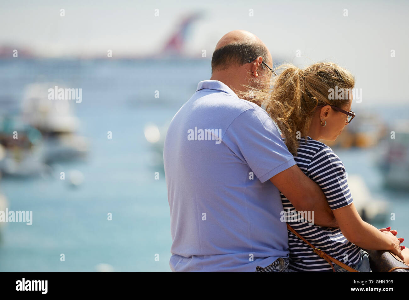 A Middle Aged Couple Embrace By The Waterfront In Avalon, Catalina ...