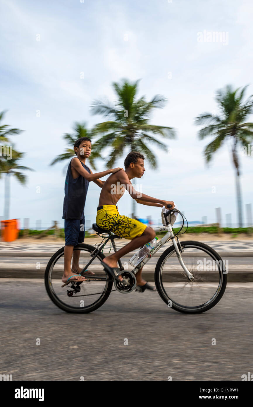 RIO DE JANEIRO - MARCH 6, 2016: Pair of young Brazilians ride a bicycle ...