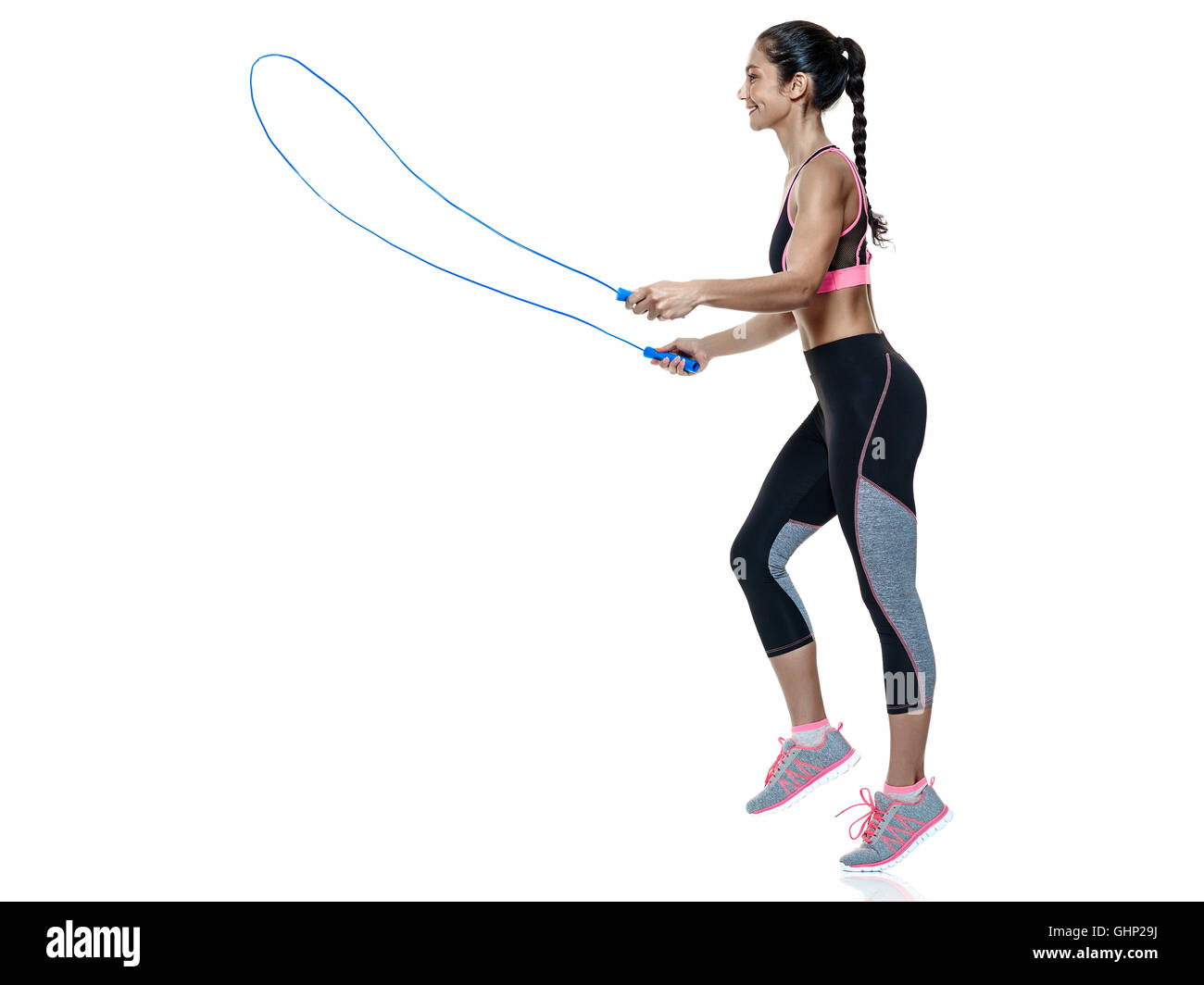 one mixed raced woman exercising fitness jumping rope exercises ...