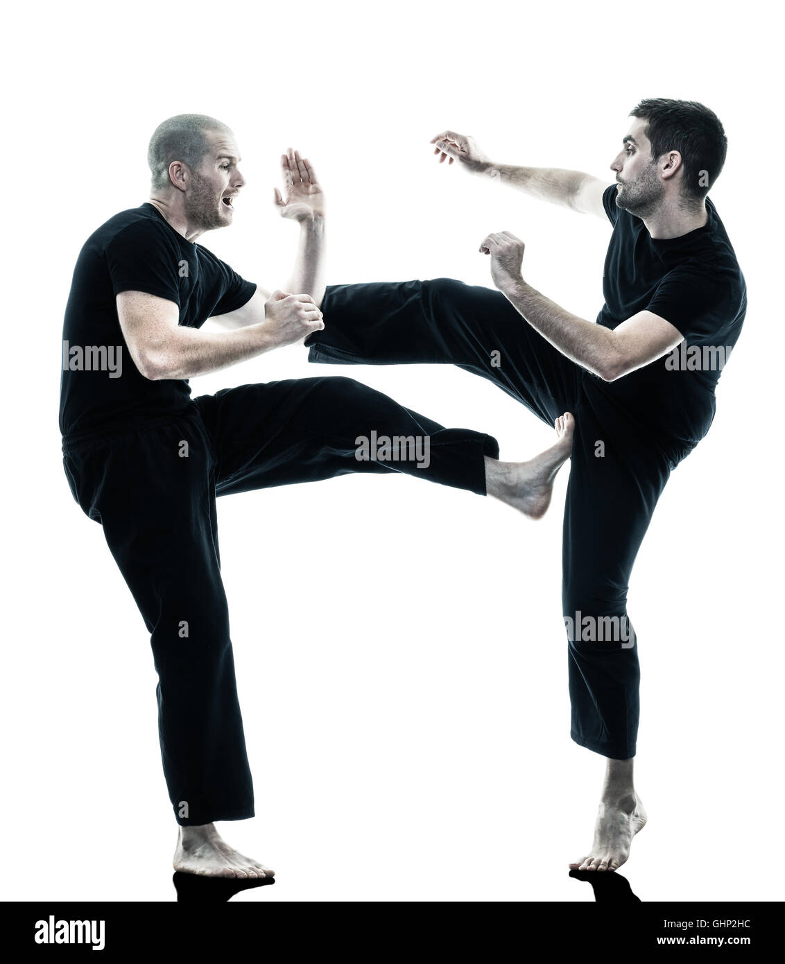 two caucasian men krav maga fighters fighting isolated silhouette on ...