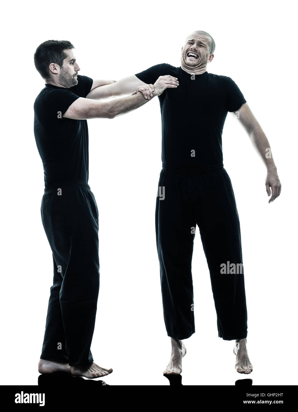 two caucasian men krav maga fighters fighting isolated silhouette on ...