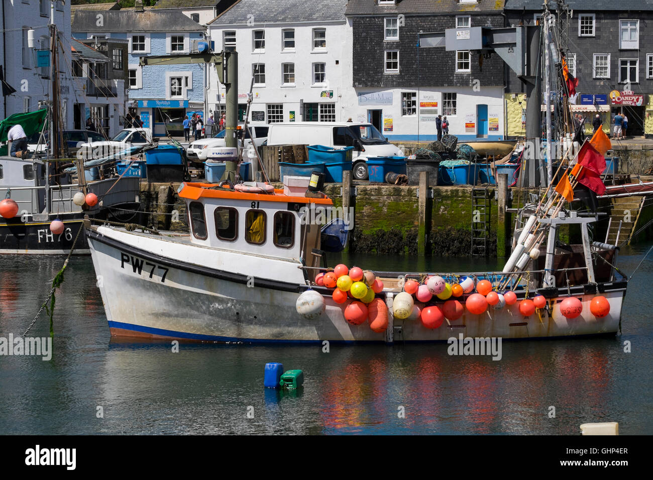 FIshing boats with brightly coloured floats in Mevagissey Harbour ...