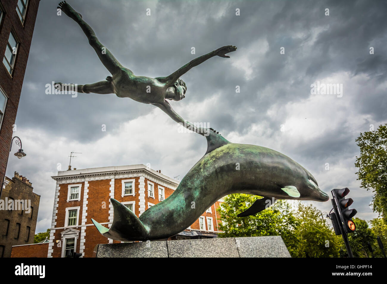 Dolphin and boy statue hi-res stock photography and images - Alamy