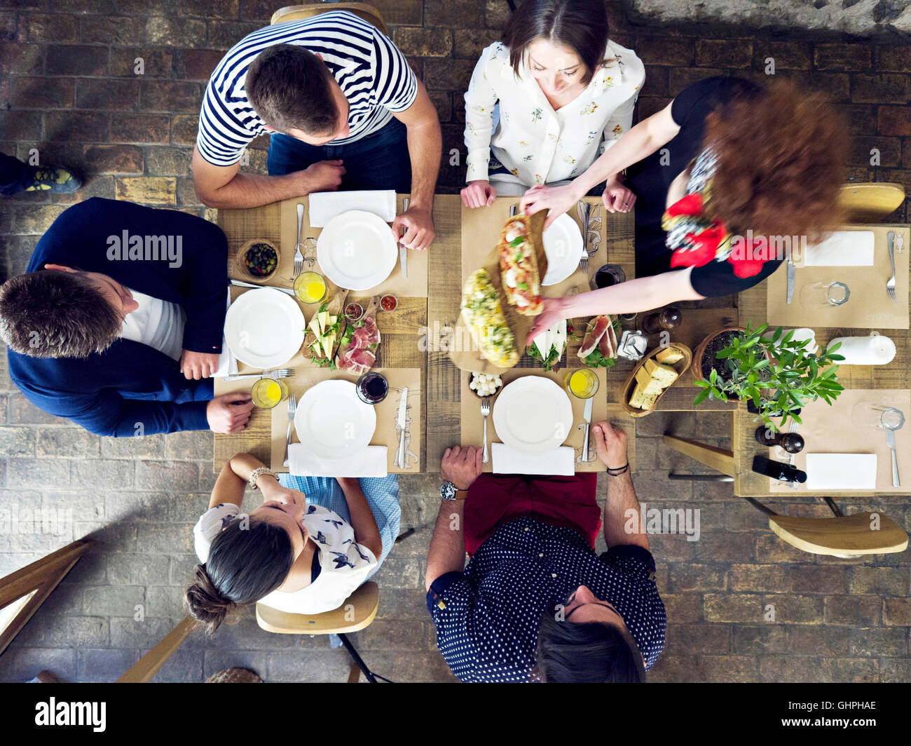 Group of friends having lunch in restaurant Stock Photo - Alamy