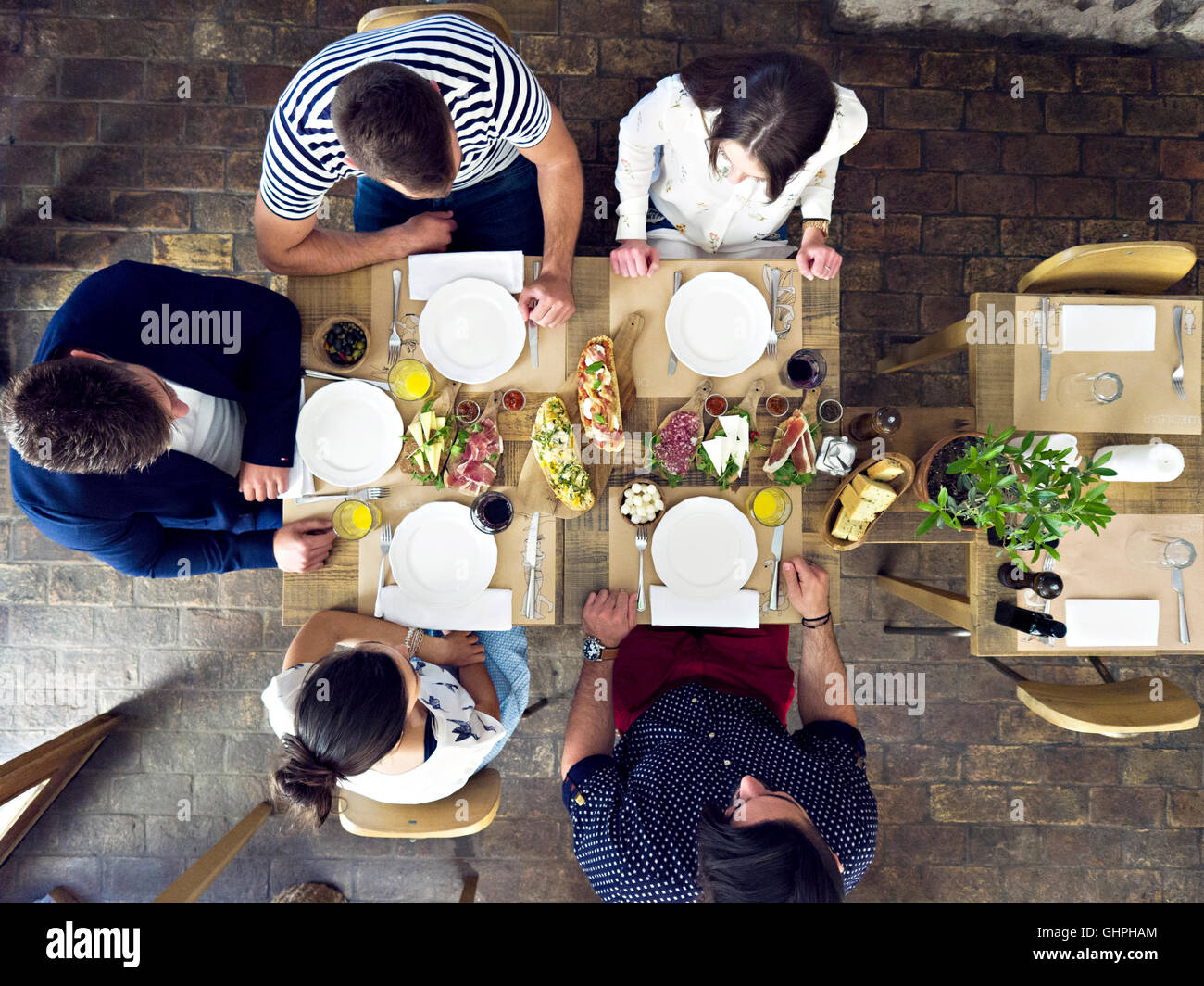 Group of friends having lunch in restaurant Stock Photo - Alamy