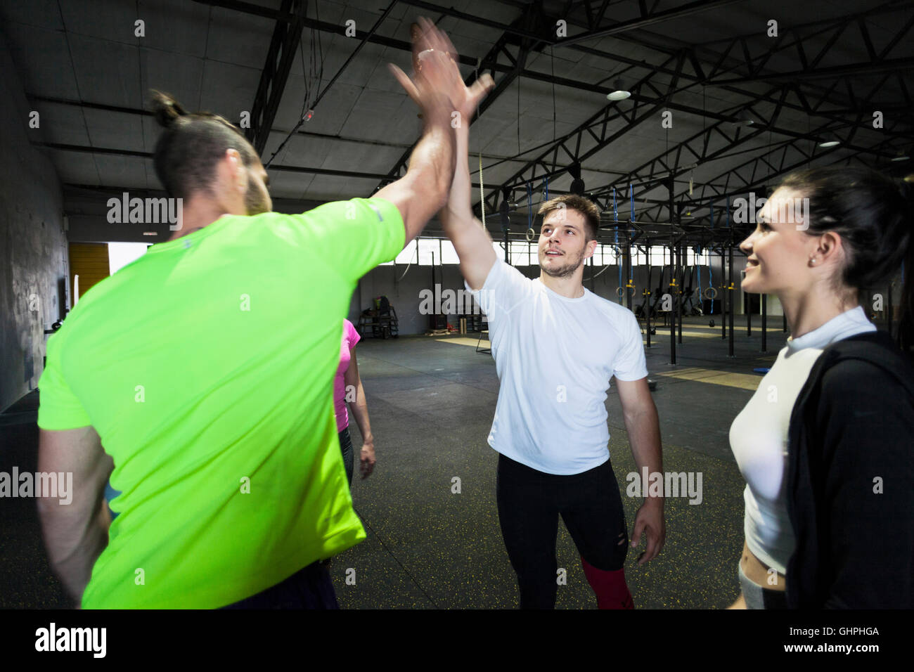 Athletes giving high five at gym Stock Photo - Alamy
