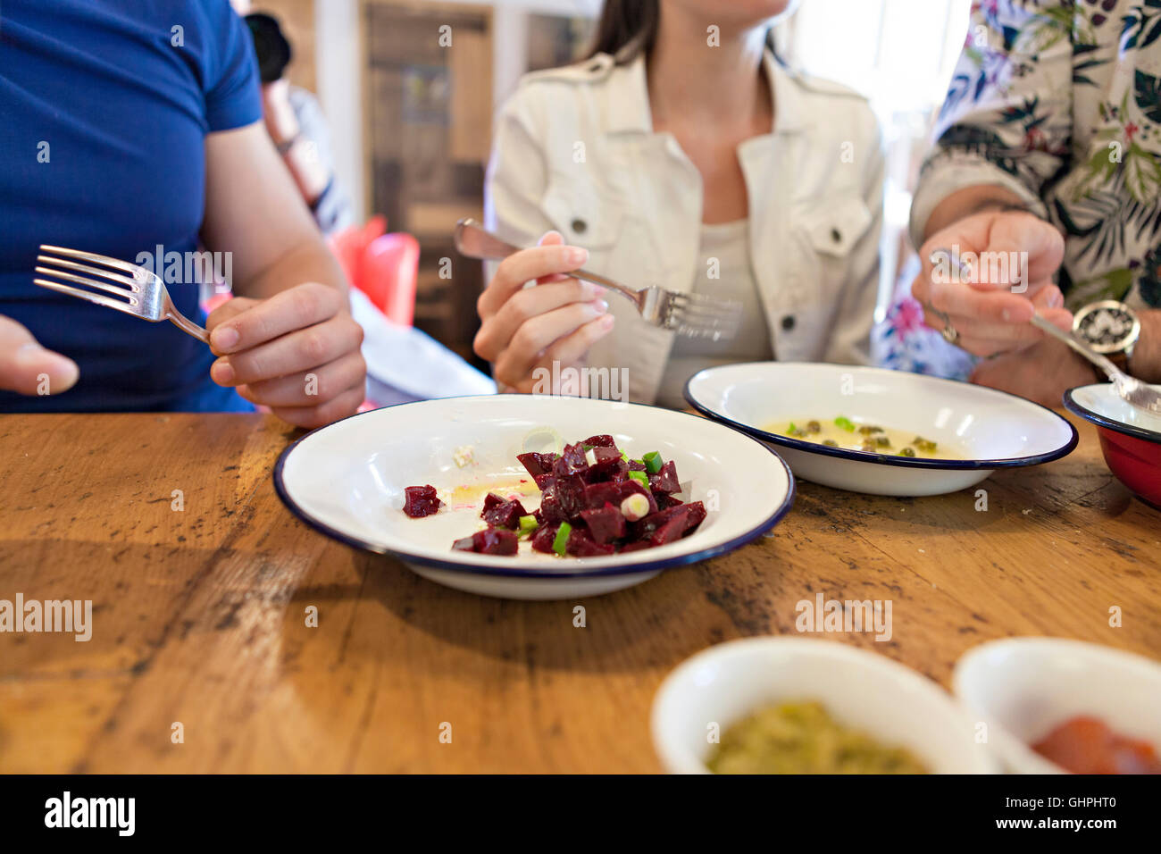 Young people dining at counter in restaurant Stock Photo - Alamy