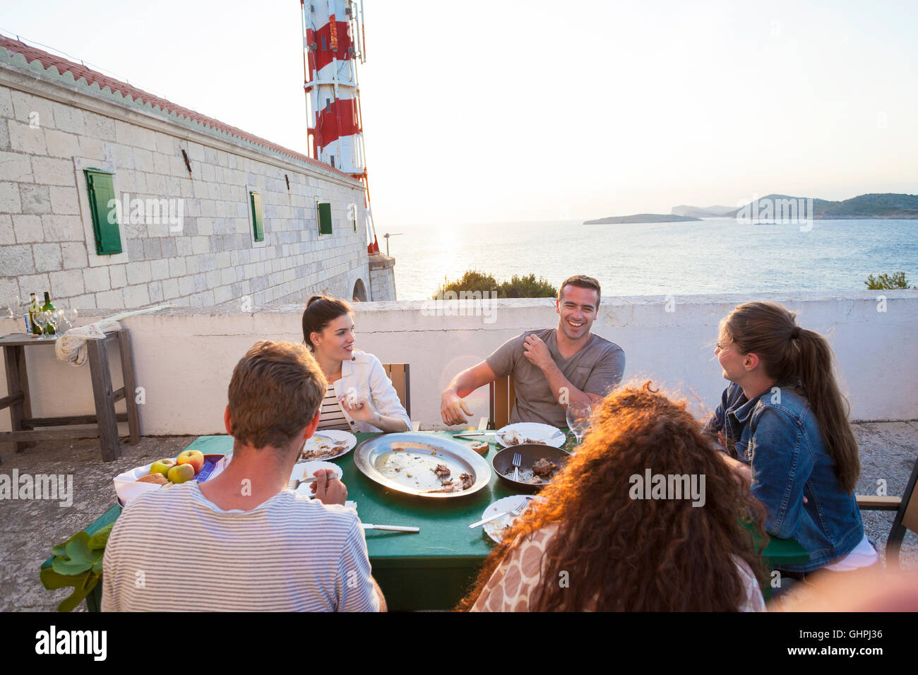 Group of friends celebrating at the seaside Stock Photo - Alamy