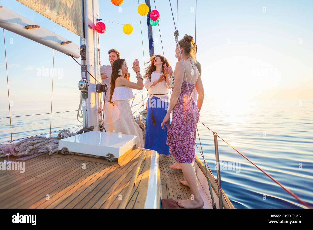 Friends celebrating and laughing on sailboat Stock Photo - Alamy
