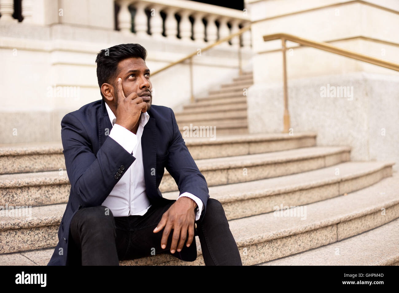 Indian man sitting on steps hi-res stock photography and images - Alamy