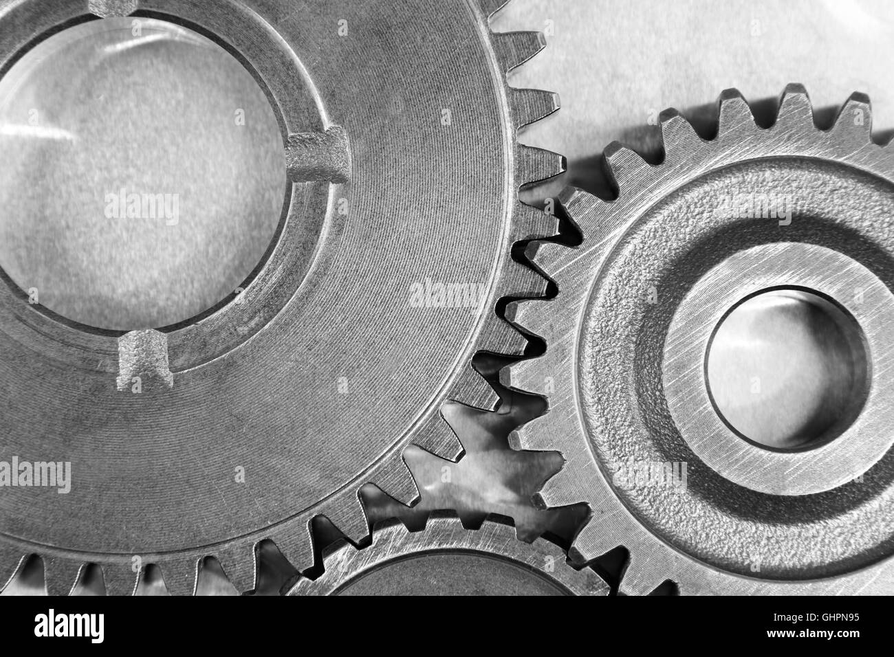 Metal cog gears joining together Stock Photo - Alamy