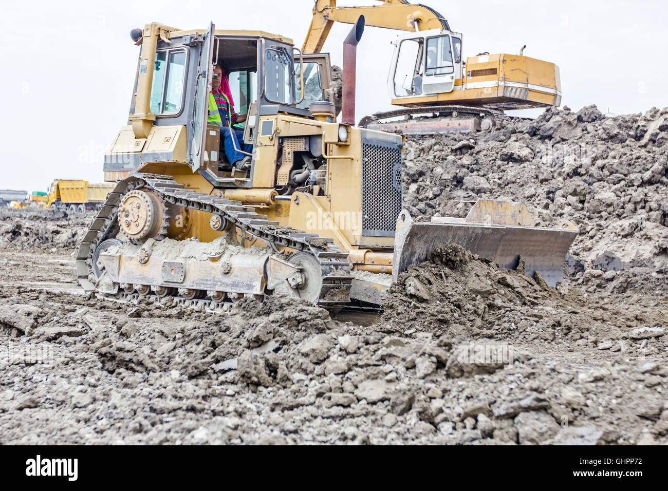 View on construction site with machinery, bulldozer is leveling ...