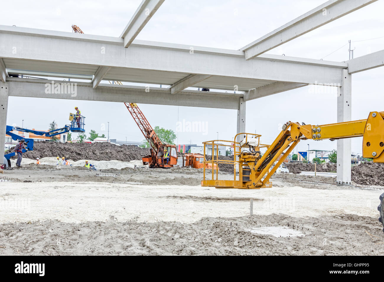 High elevated cherry picker with rigger on construction site Stock ...