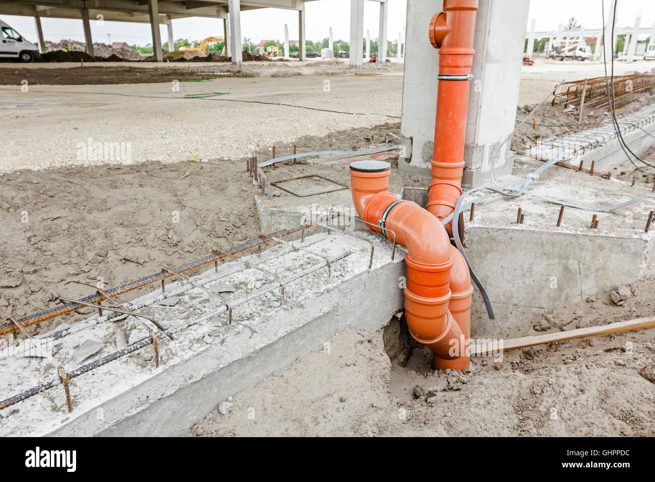 Unfinished orange rain drain pipe system for gutter on new building ...