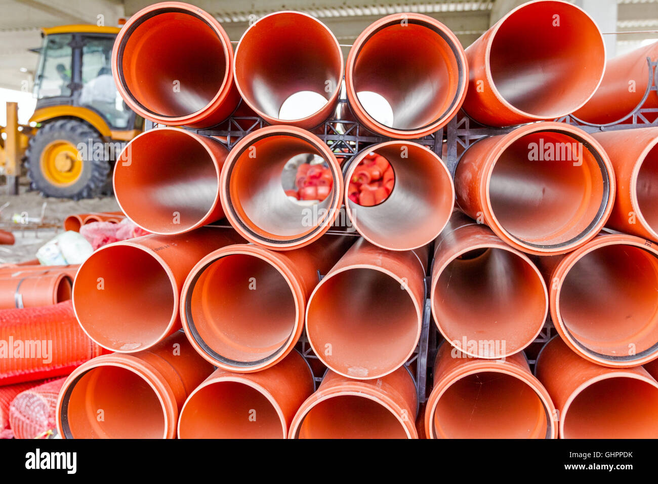 Sewer pipes waiting to be placed into the ditch at construction site ...