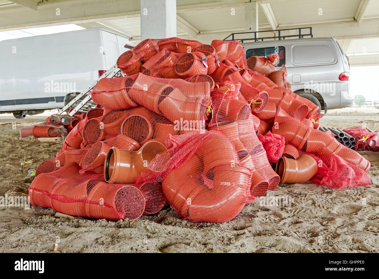 Sewer pipes waiting to be placed into the ditch at construction site ...