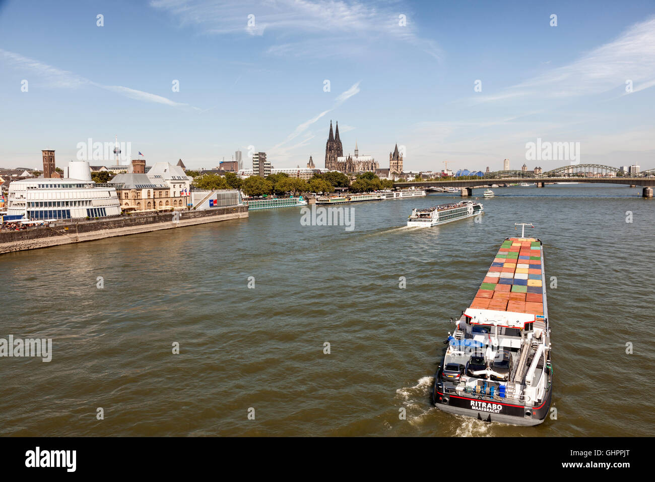 Container ship and cruise ship at the Rhine river in Cologne, Germany ...