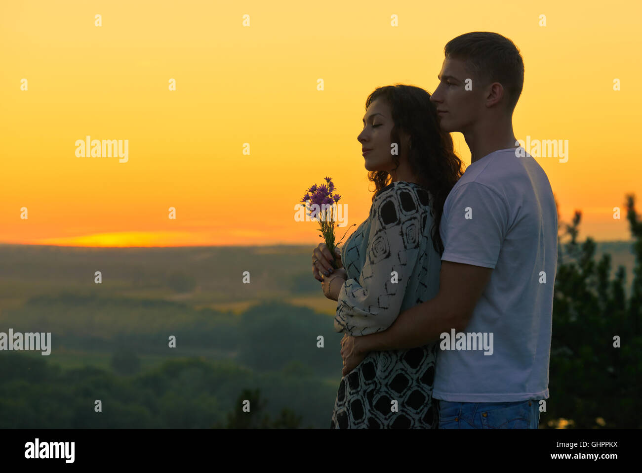 romantic couple look on sunset on country outdoor, beautiful landscape ...