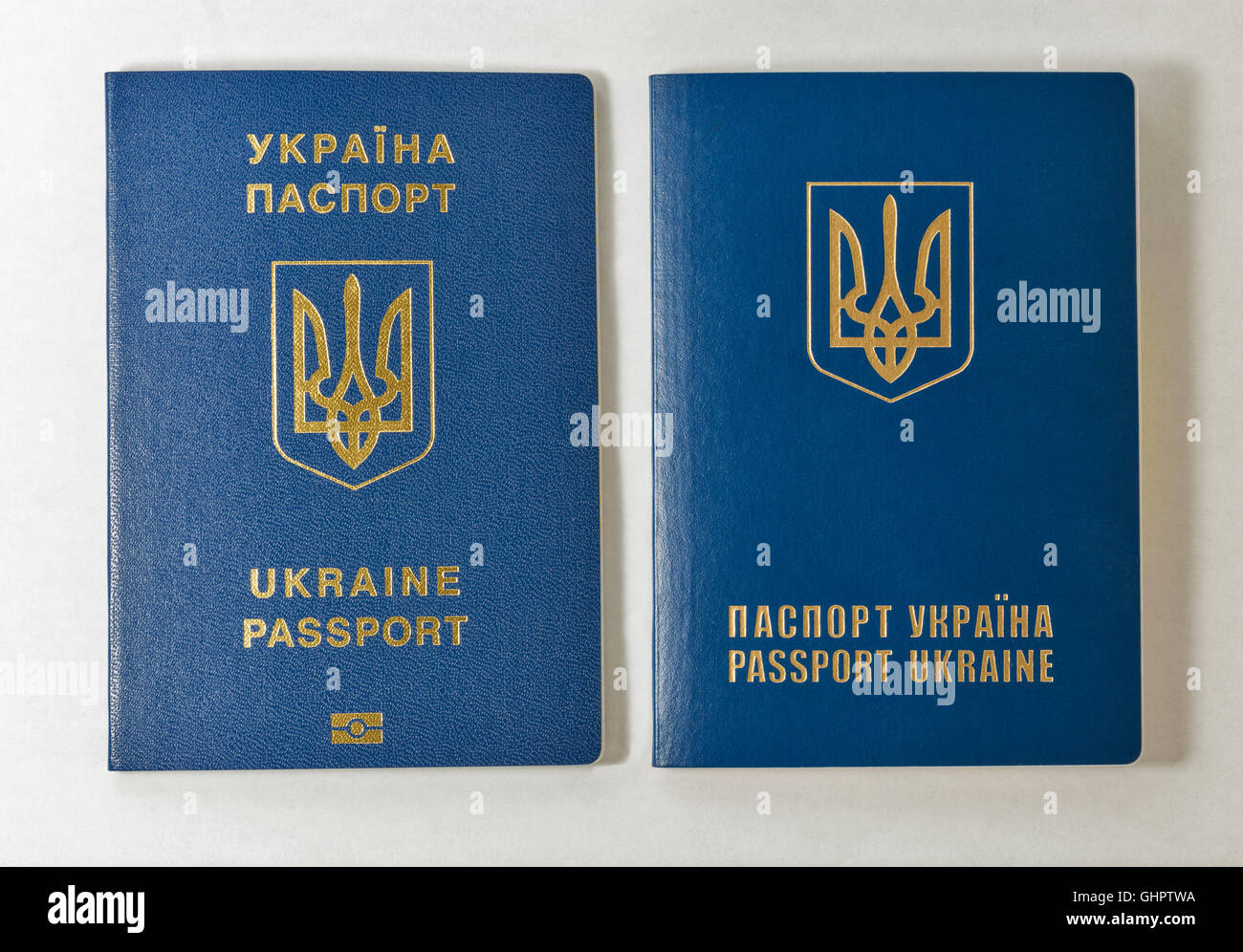 Ukrainian biometric and common passports against white background ...