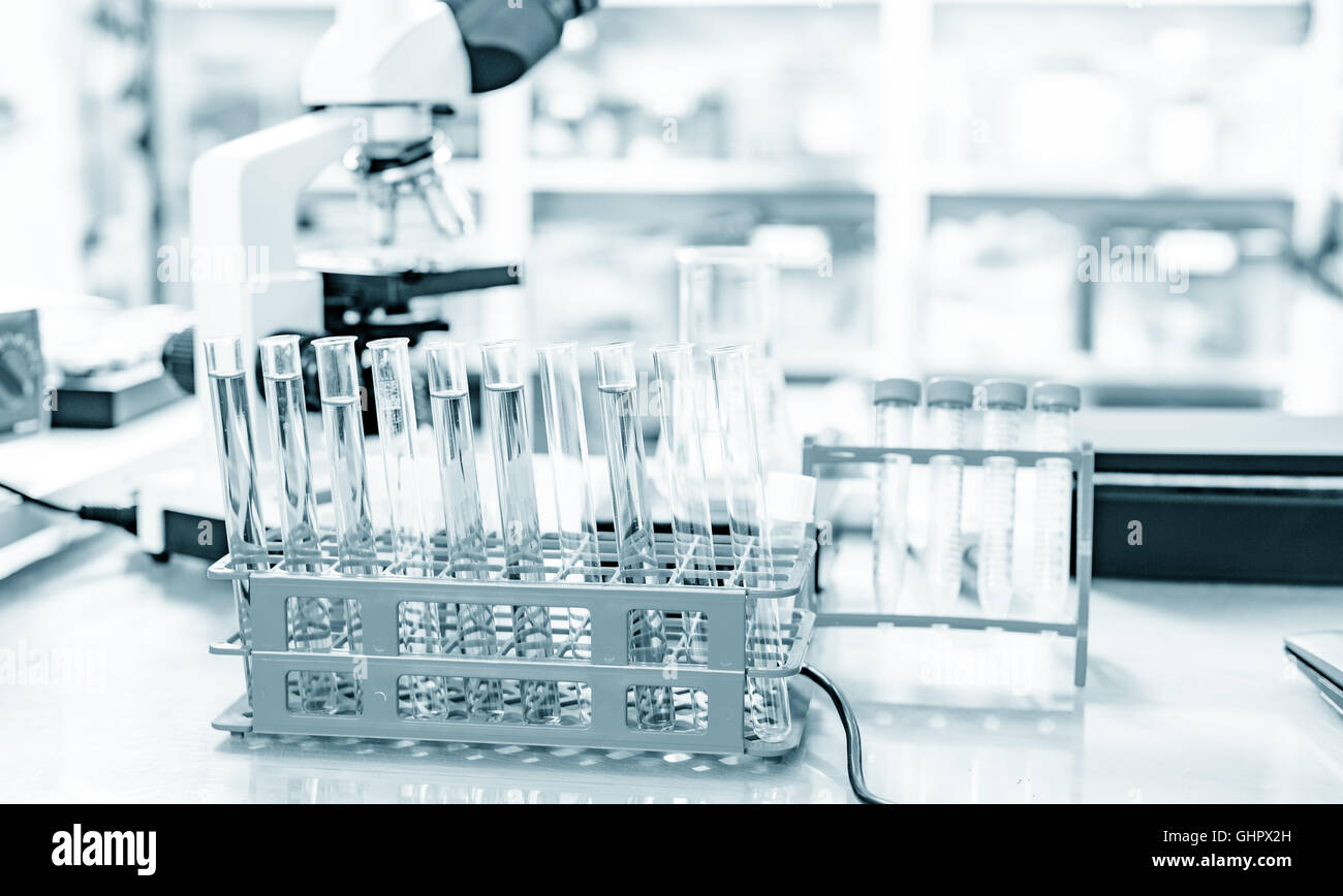 Microscope and test tubes on laboratory bench Stock Photo - Alamy