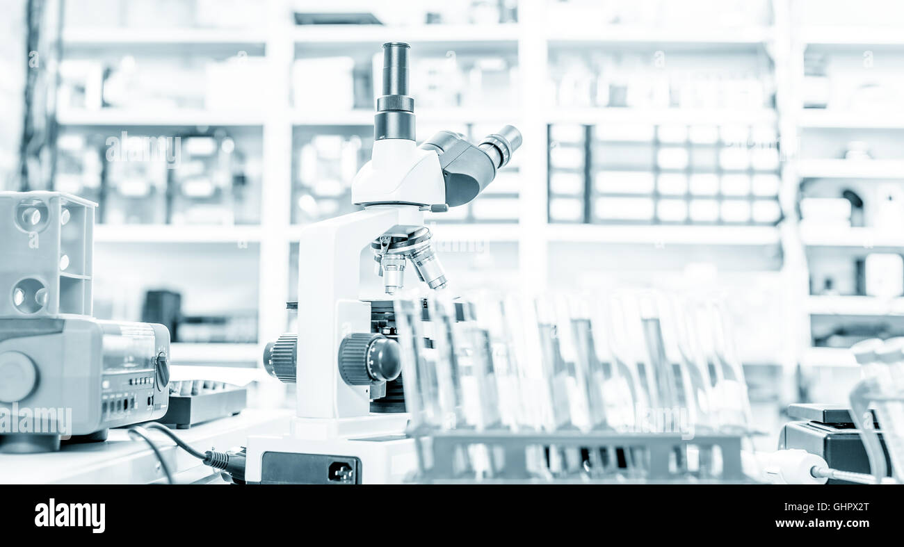 Microscope and test tubes on laboratory bench Stock Photo - Alamy