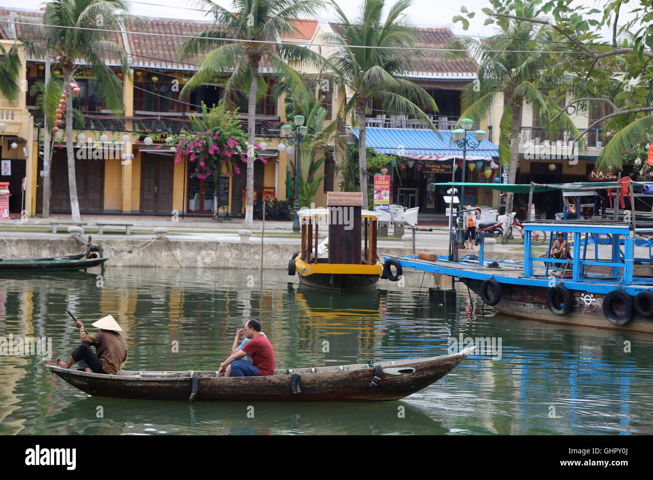 A person being ferried across the river in a little boat, Hoi An ...