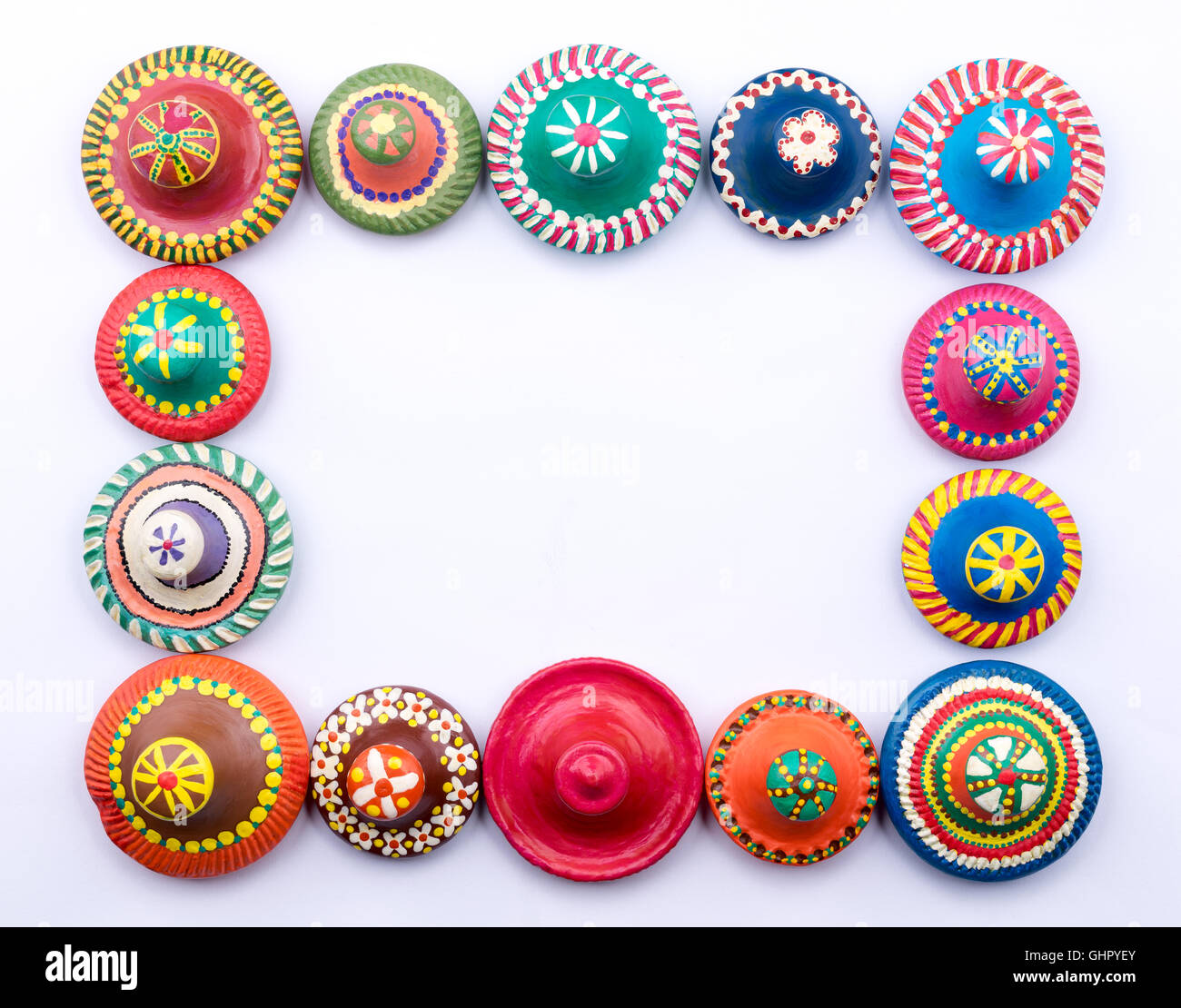 Frame of painted colorful pottery lids on white background Stock Photo ...