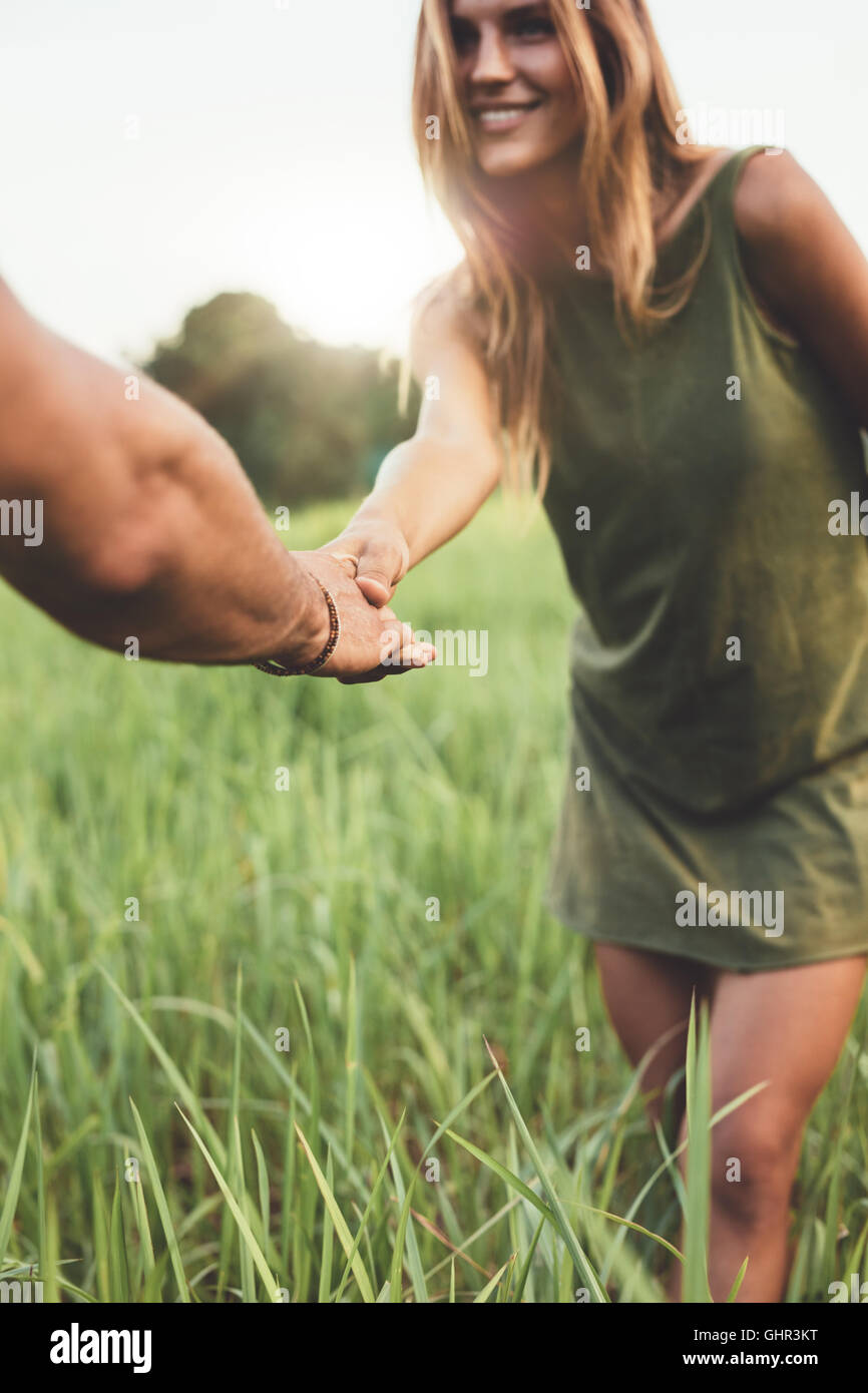 Couple Holding Hands In Field