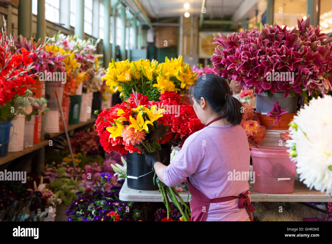 Seattle, Washington: A merchant arranges bouquets of summer flowers at ...