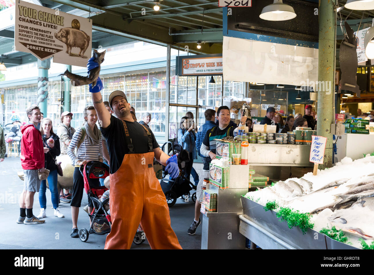 Seattle, Washington: Ryan catches a fish at Pike Place Fish Market ...