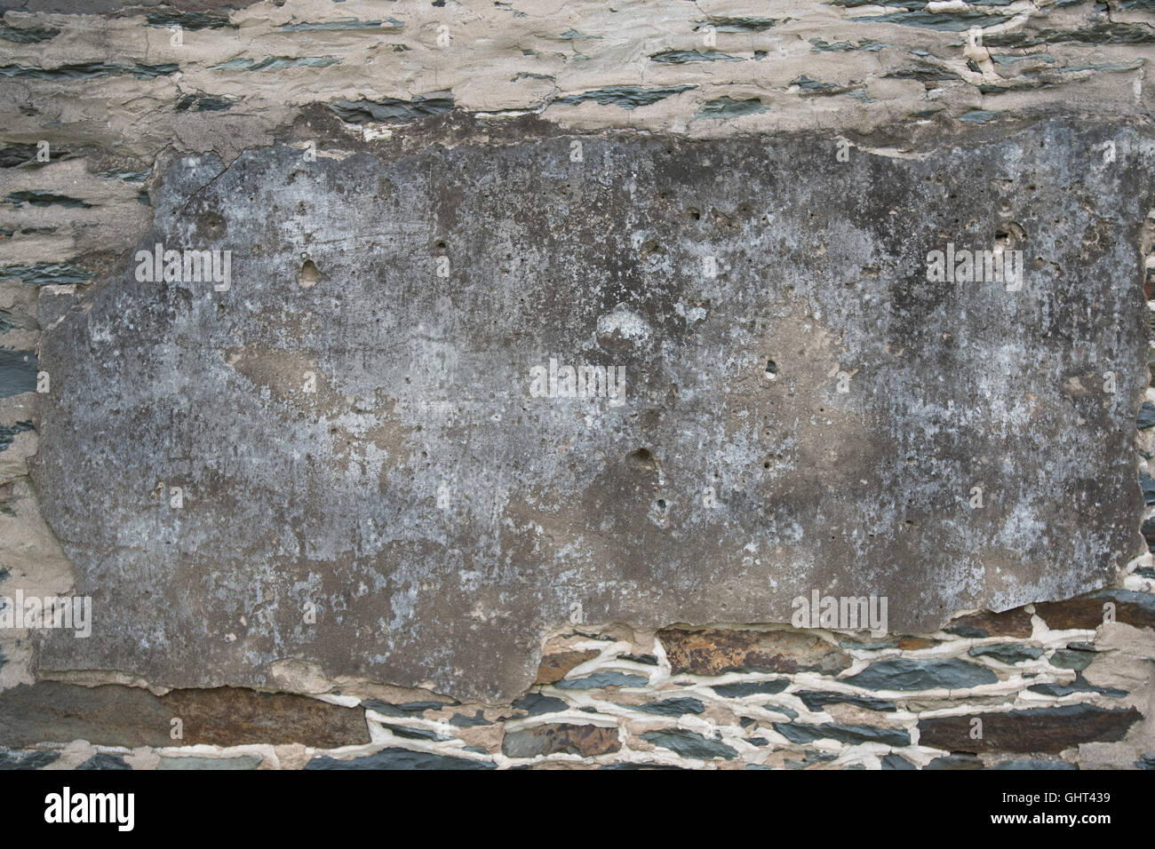 Aged Stone Wall with Patch in center Stock Photo - Alamy