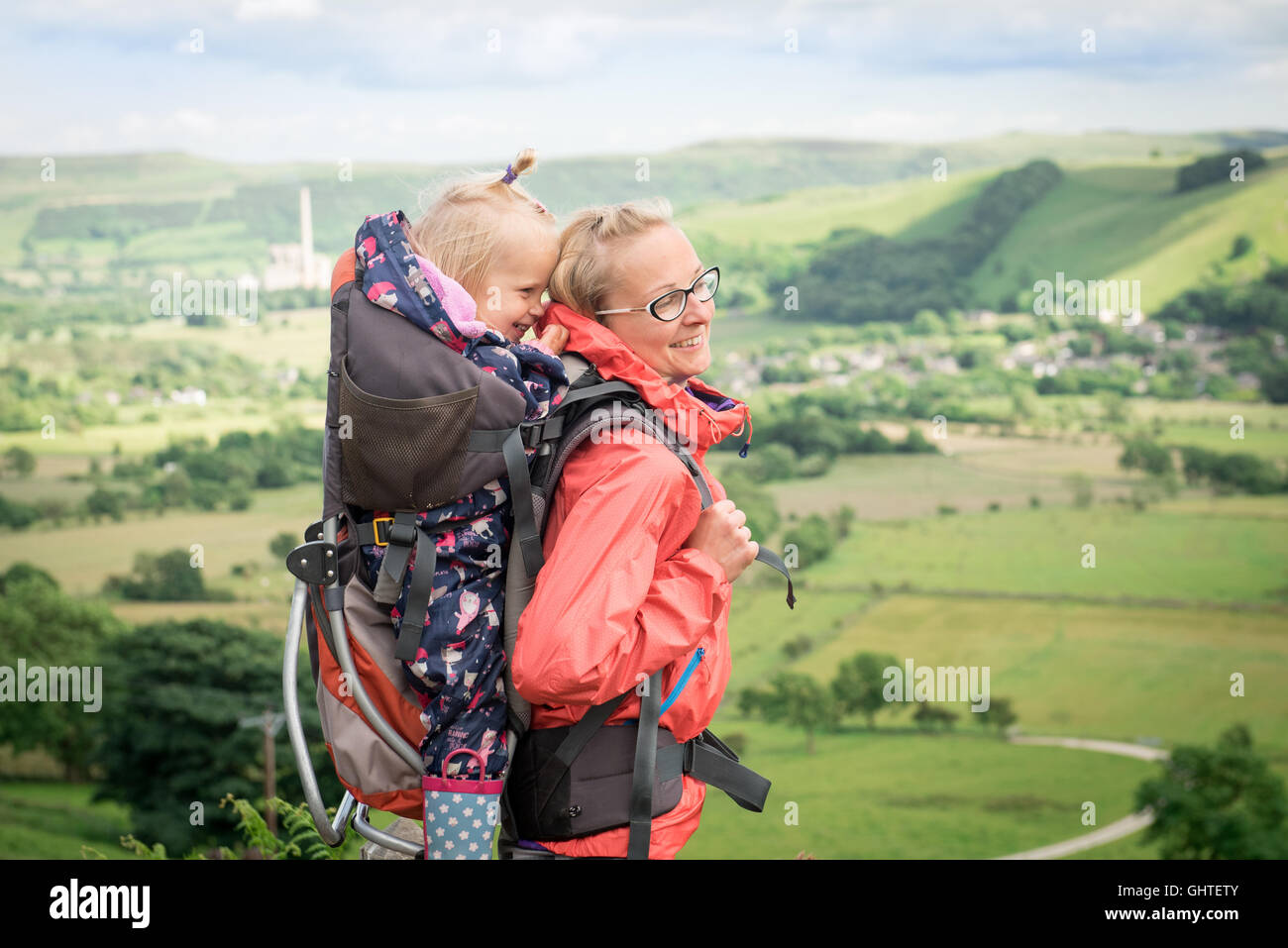 Mother carrying baby girl on her back hi-res stock photography and ...