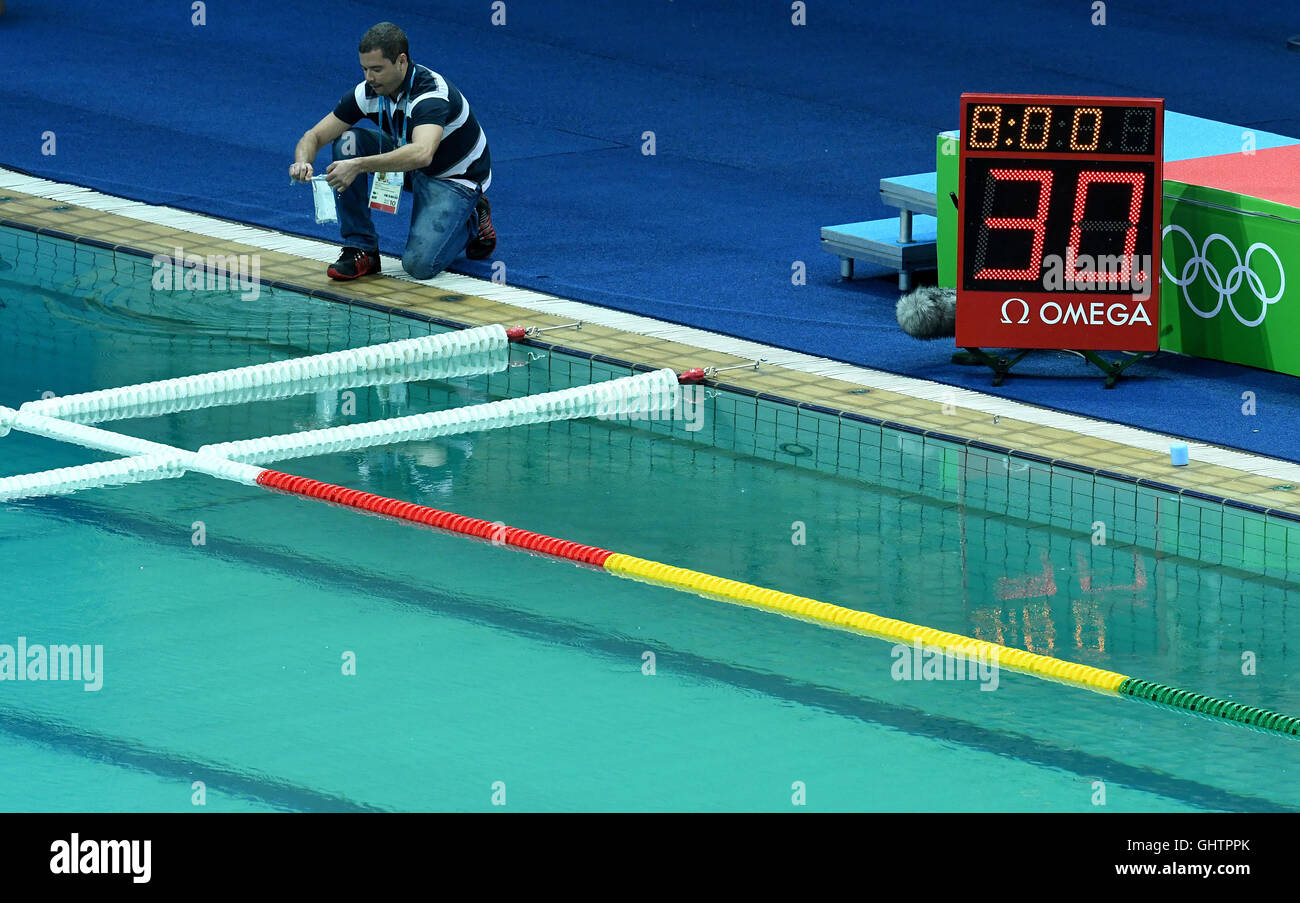 Rio de Janeiro, Brazil. 10th Aug, 2016. A man takes a water sample from ...