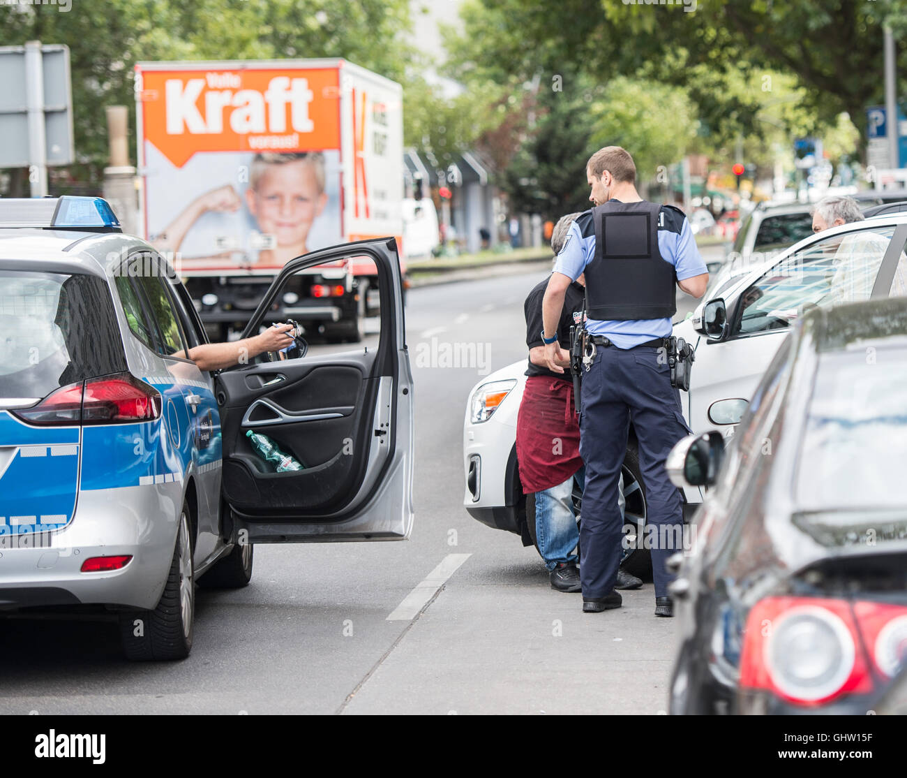 Berlin, Germany. 11th Aug, 2016. Policemen controlling two men that ...