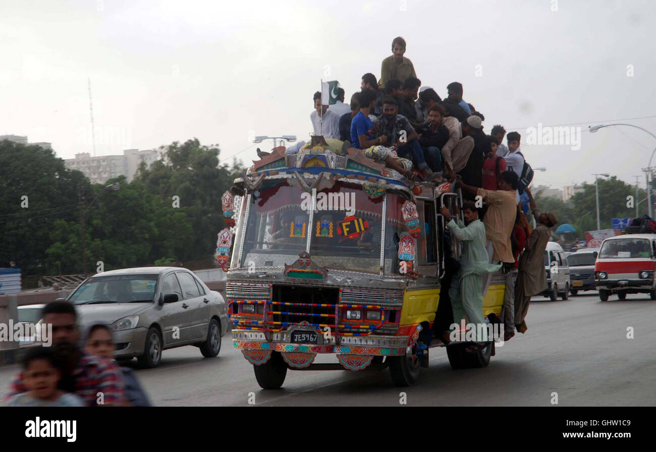 Passengers are traveling on roof of an overloaded bus due to shortage ...