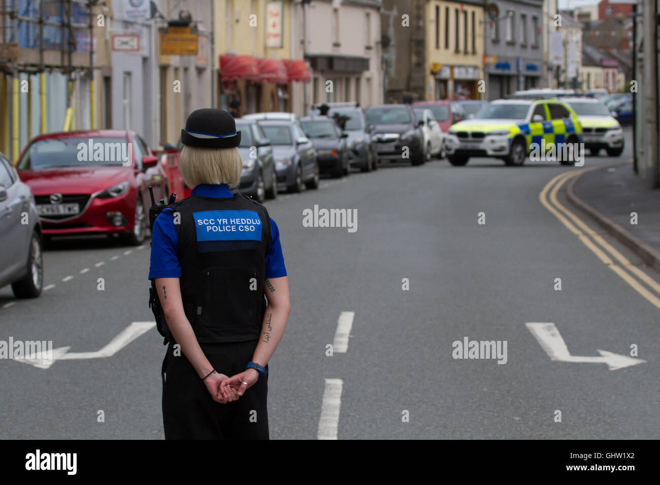 Police Community Support Officer (CSO) keeps watch at an incident in a ...