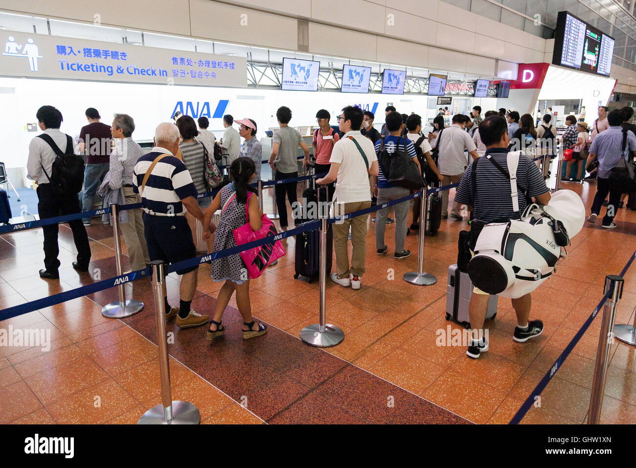 Tokyo, Japan. 11th August, 2016. Passengers queue at a check-in desk at ...