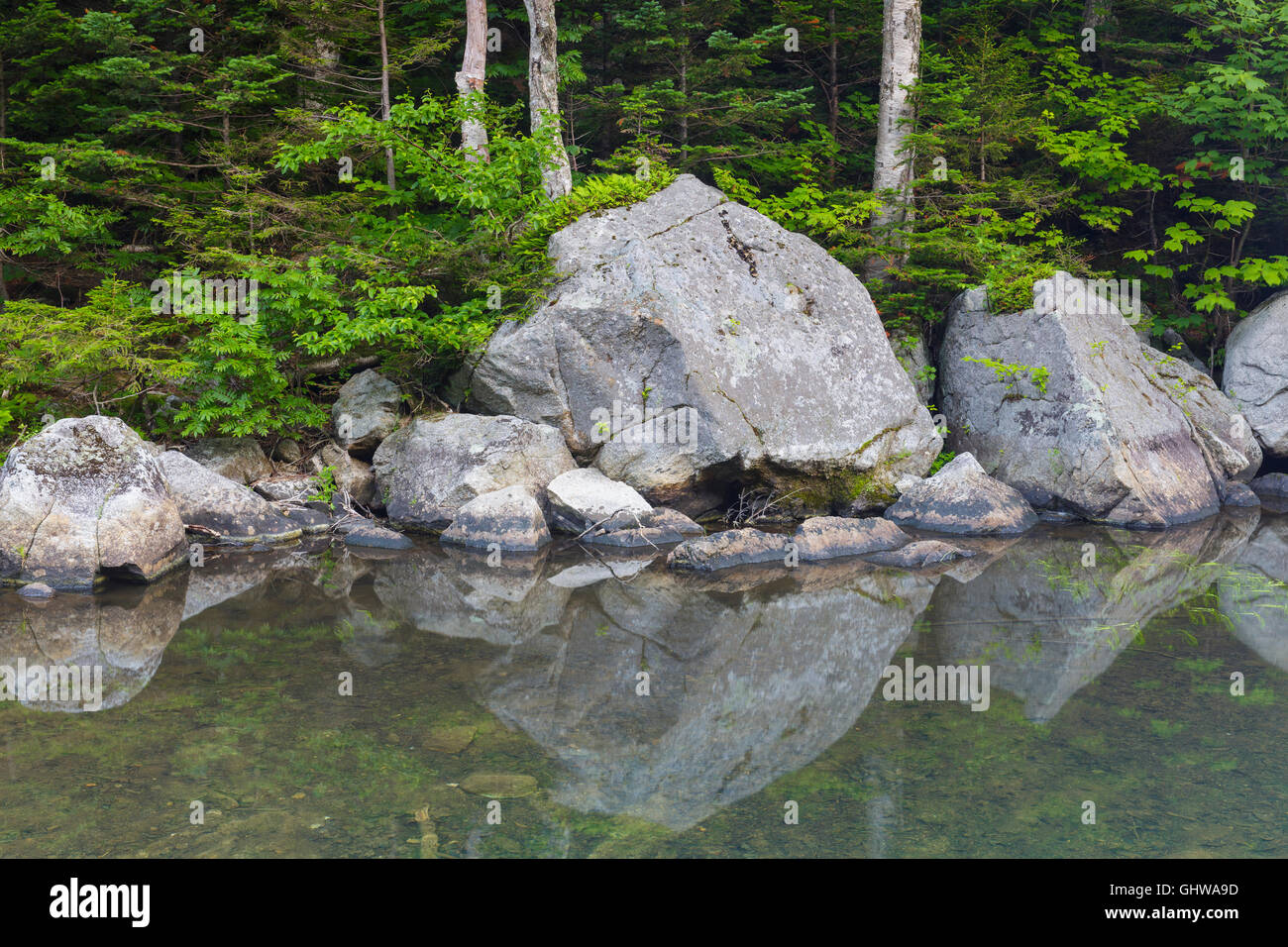 Reflection of rocks in Profile Lake in Franconia Notch State Park of ...