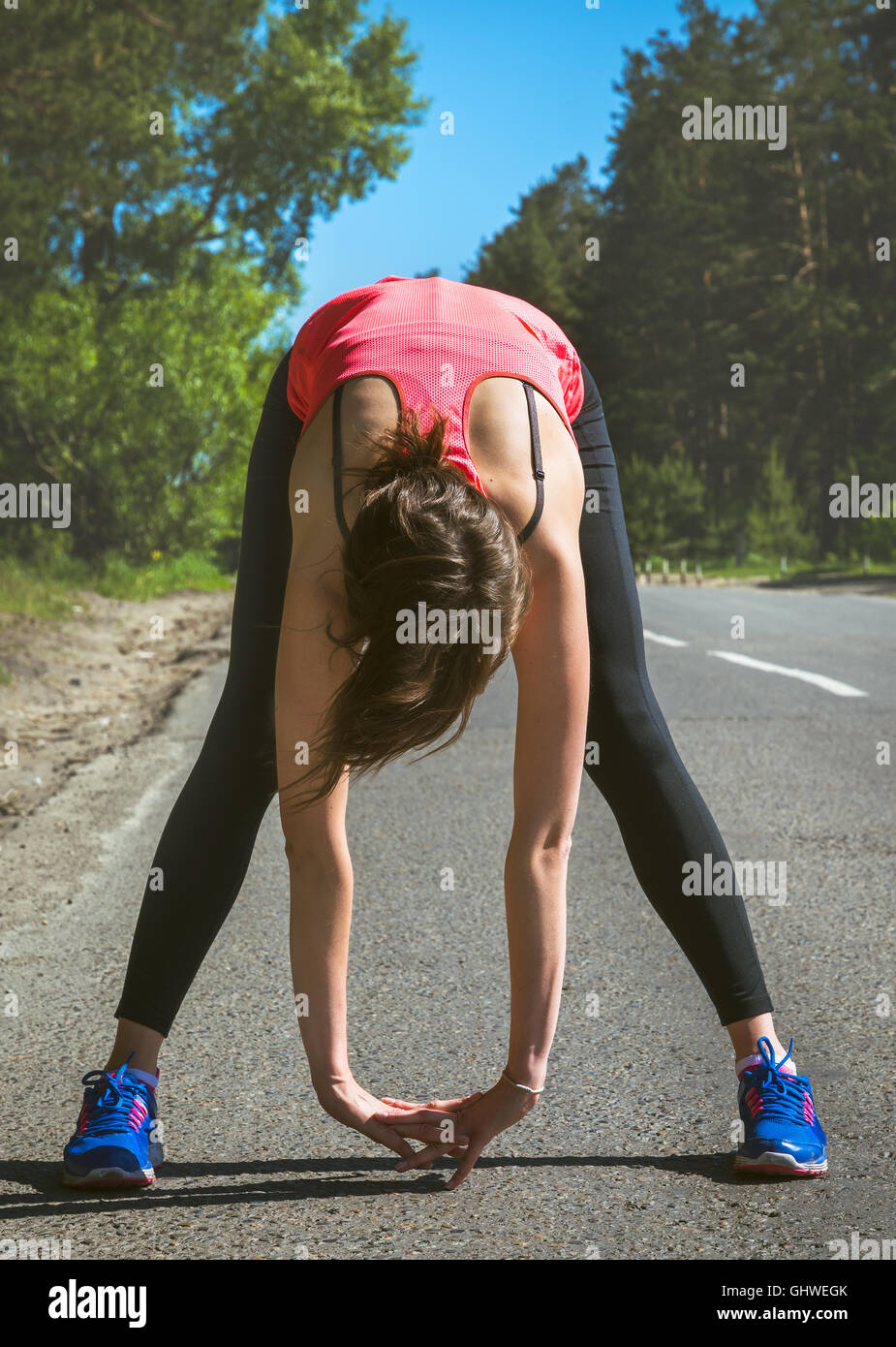 Young fitness woman runner stretching before run. Runner athlete jogging workout wellness ...