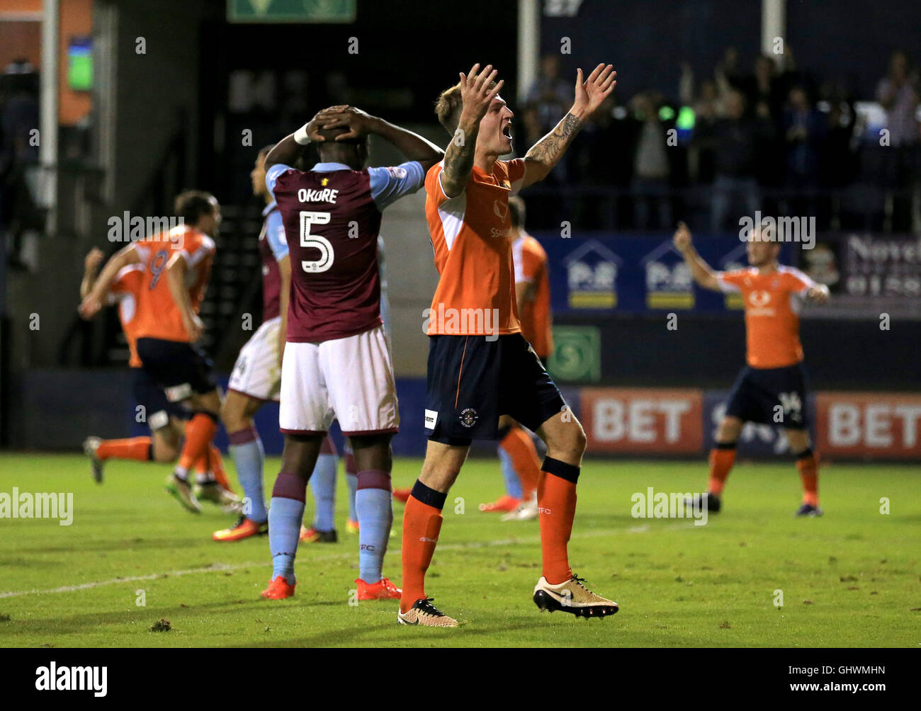 Aston Villa's Jores Okore (left) holds his head after scoring an own ...